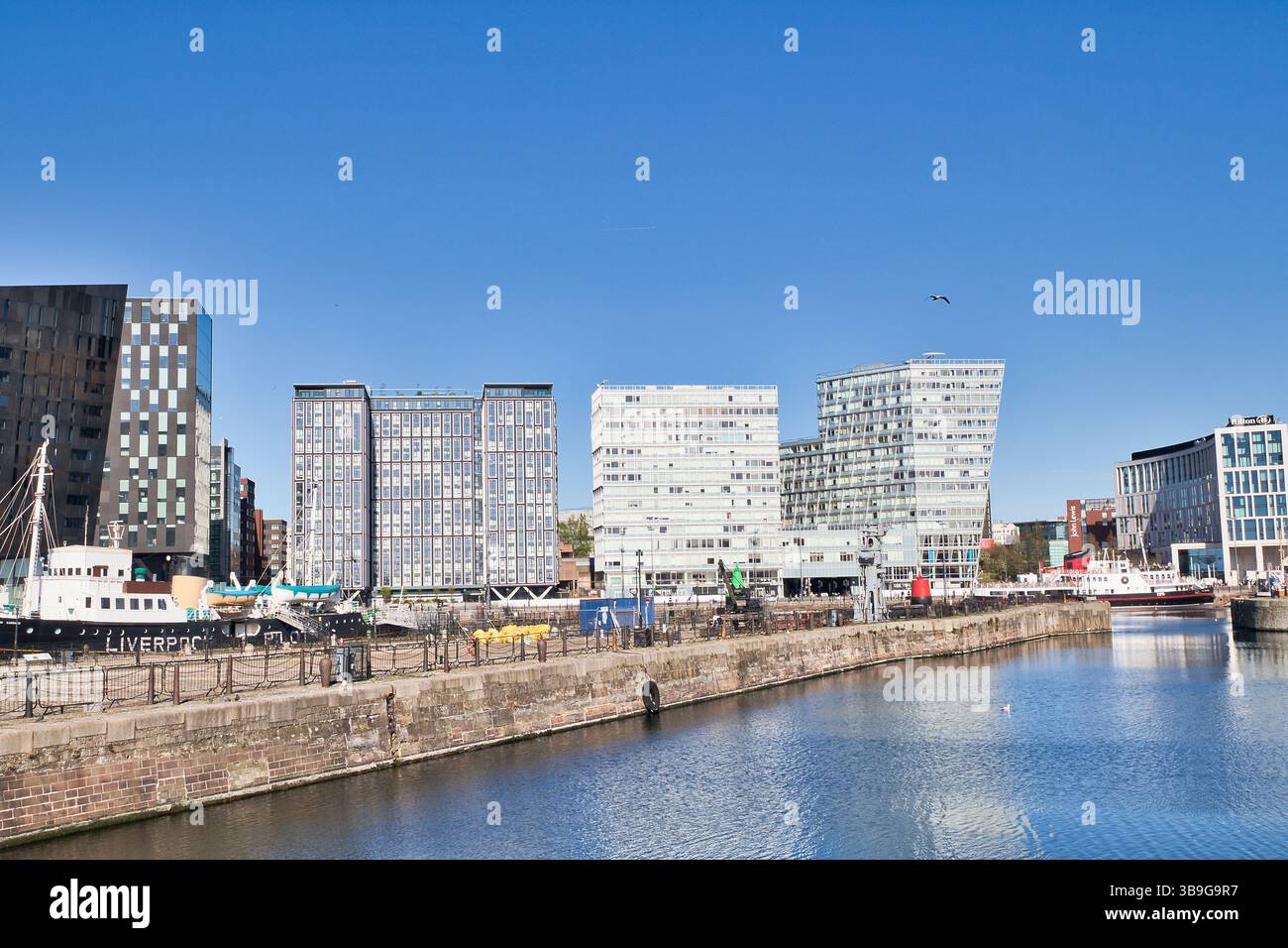 Urban waterfront view of modern buildings and docked ships under a ...