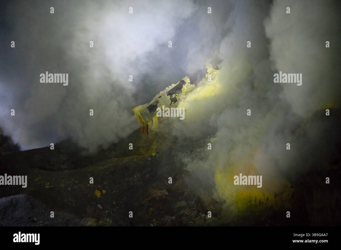 Thick sulfur smoke rises from Ijen’s crater vents, with visible yellow ...