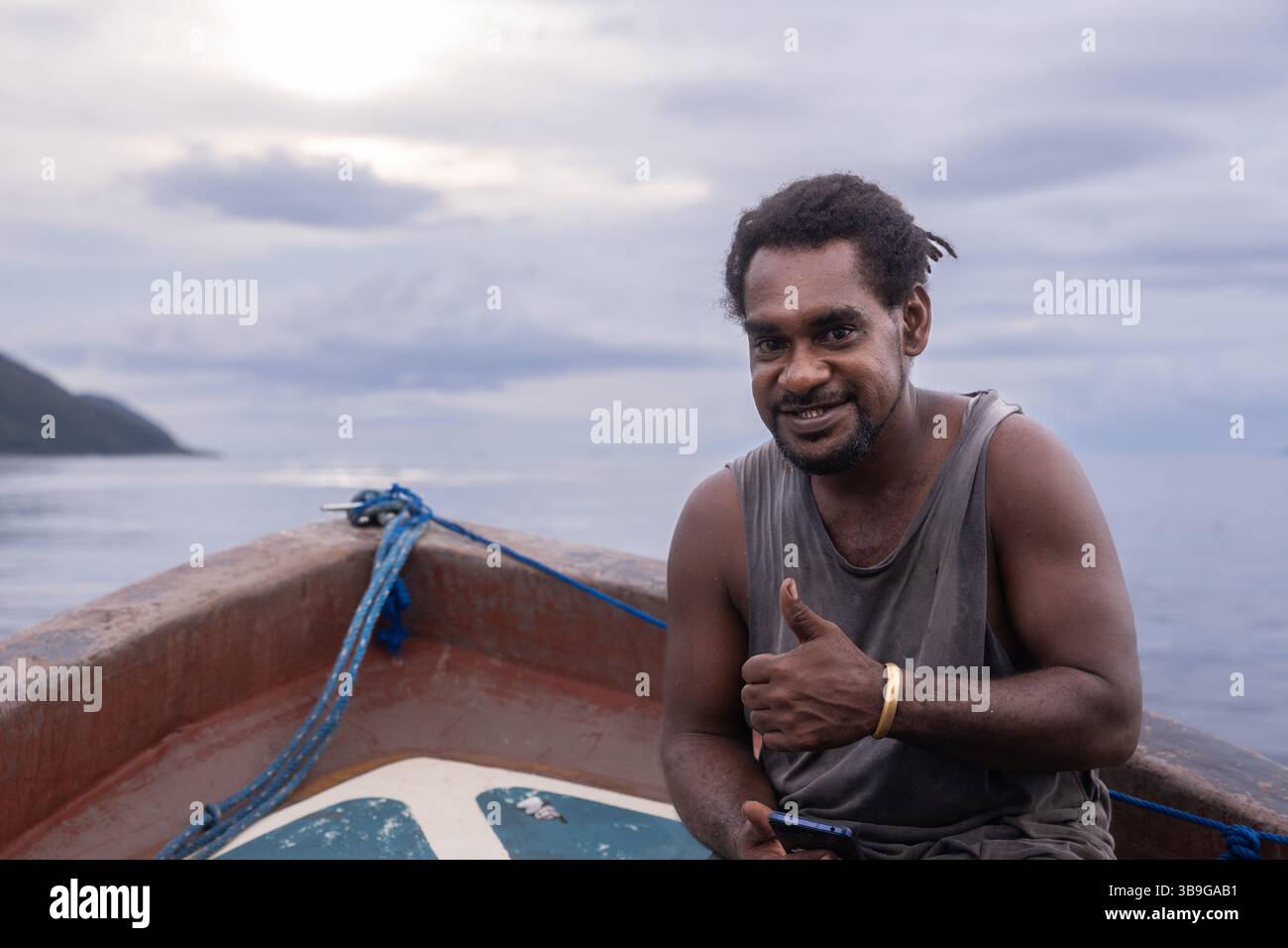 A smiling native man from Kri Island in the Raja Ampat Archipelago of ...