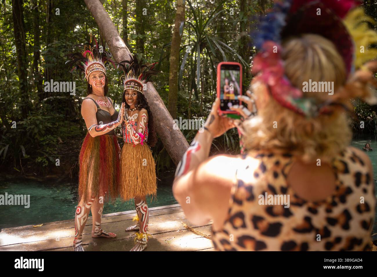 Tourist takes a photo of a friend posing with a Pacific Islander in ...
