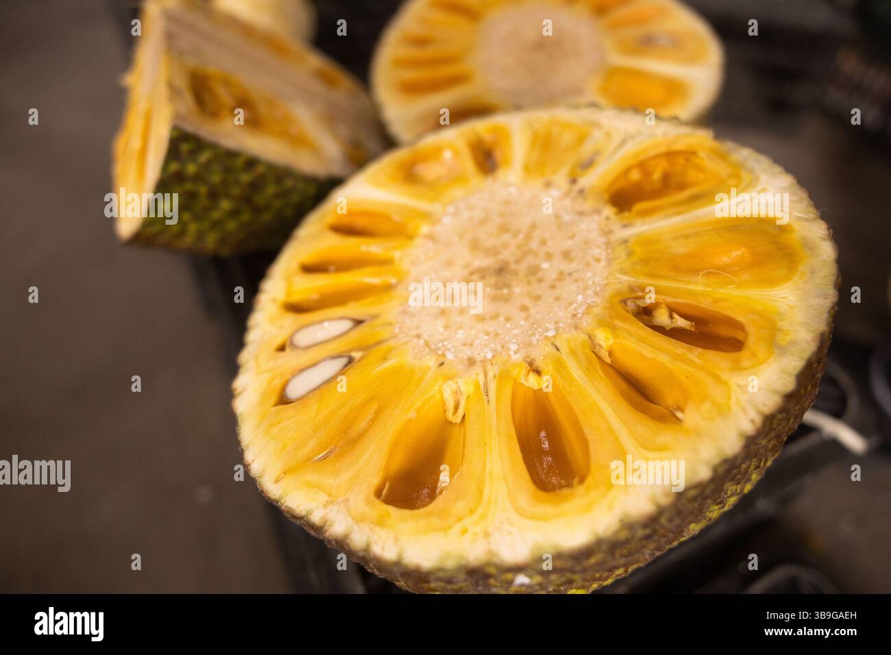 Close up of halved ripe jackfruit in a vietnamese eco market, featuring ...