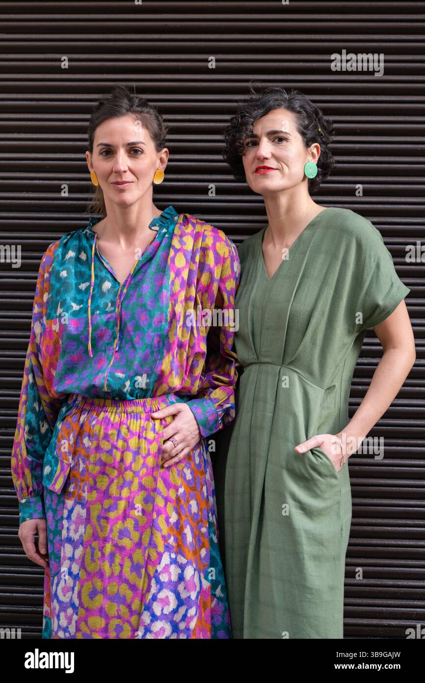 Two women showcase vibrant fashion with colorful dresses and bold ...