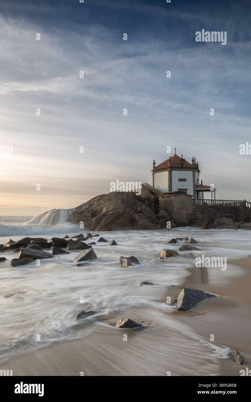 Evening atmosphere at the Capela do Senhor da Pedra beach chapel. The ...