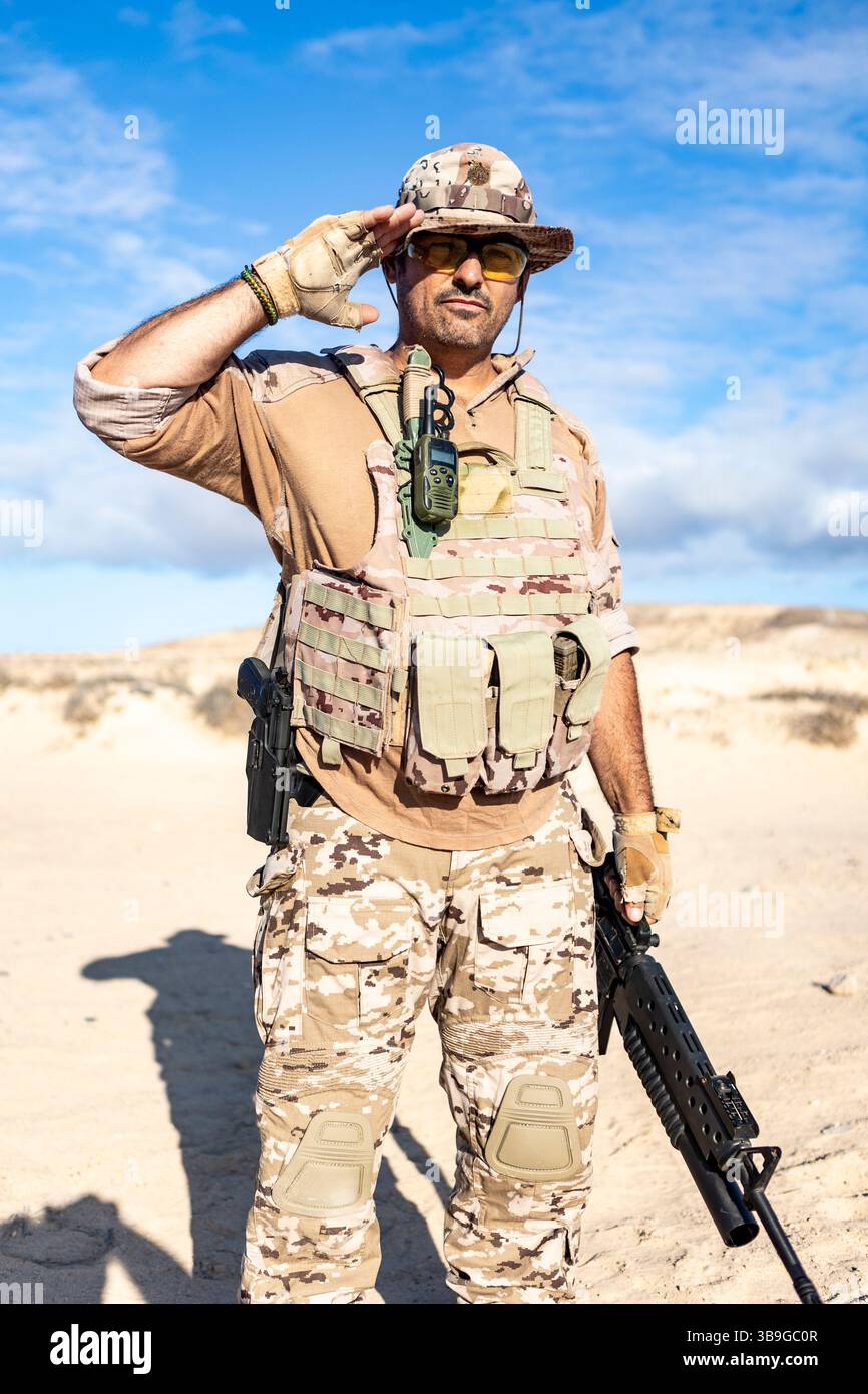 A soldier in full desert camouflage, equipped with tactical gear and a ...