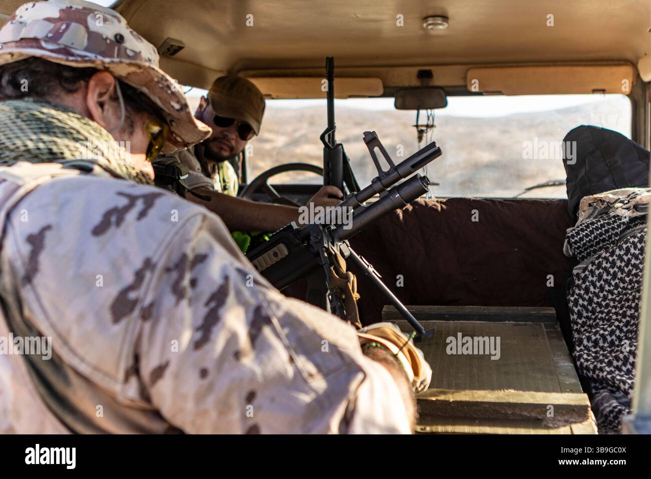 A tactical team is captured inside a military vehicle, equipped with ...