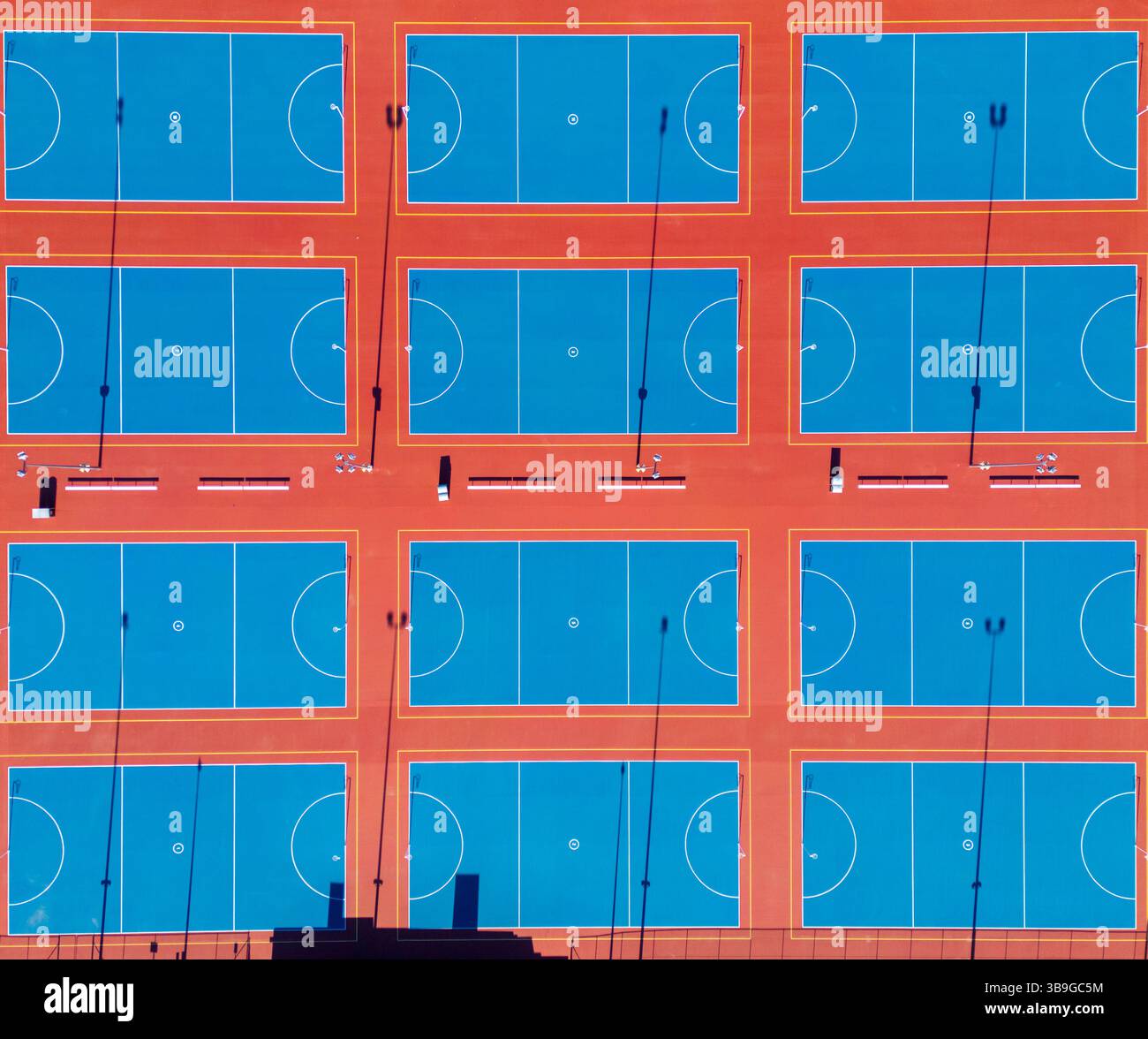 From above, this image captures a series of neatly arranged netball ...