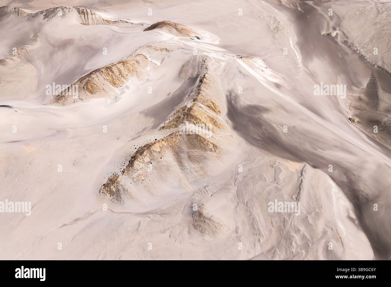 An aerial view captures the rugged desert landscape, showcasing rolling ...