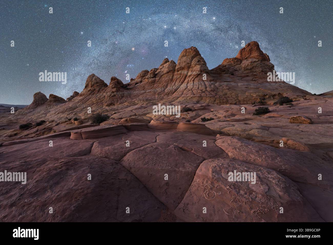 A breathtaking view of jagged rock formations under a vast, starry ...
