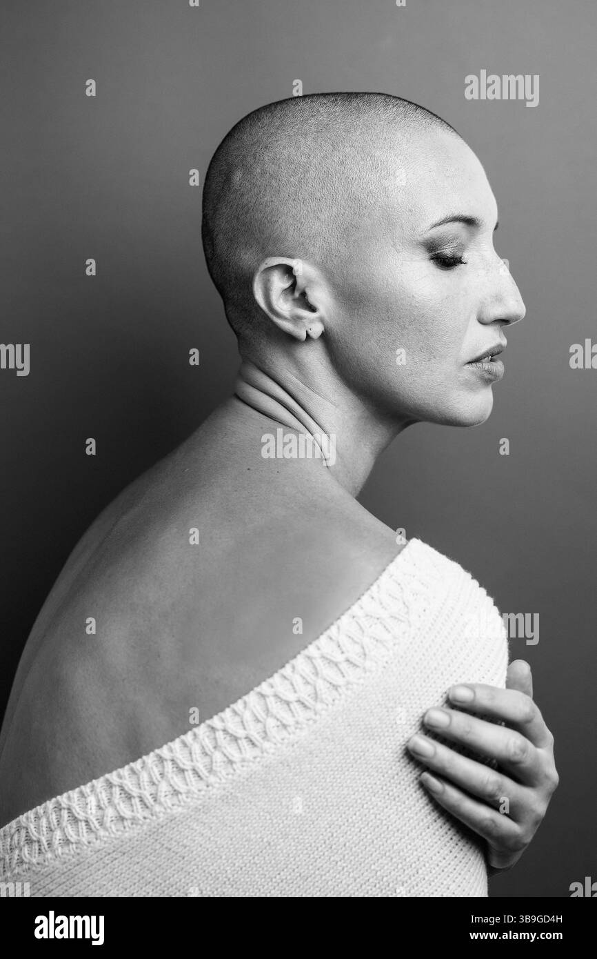 Black and white portrait of a middle aged woman with a shaved head ...
