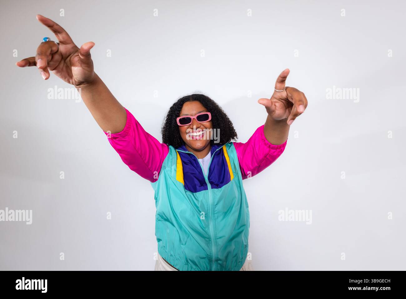 A black woman in a colorful 80s-inspired outfit, wearing pink ...