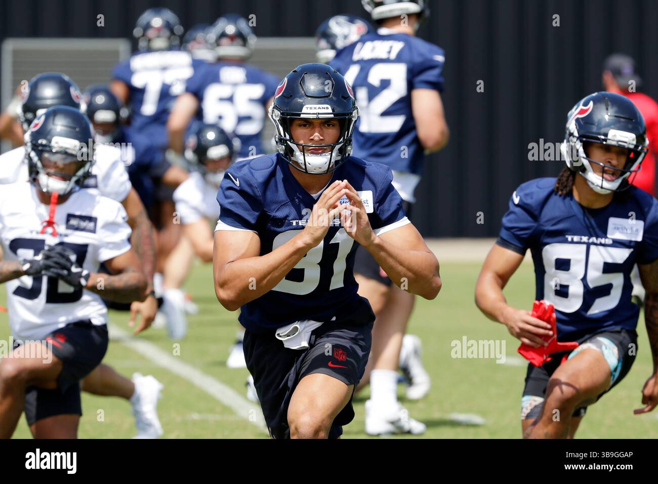 Houston Texans wide receiver Jayden Higgins, center, warms up with ...