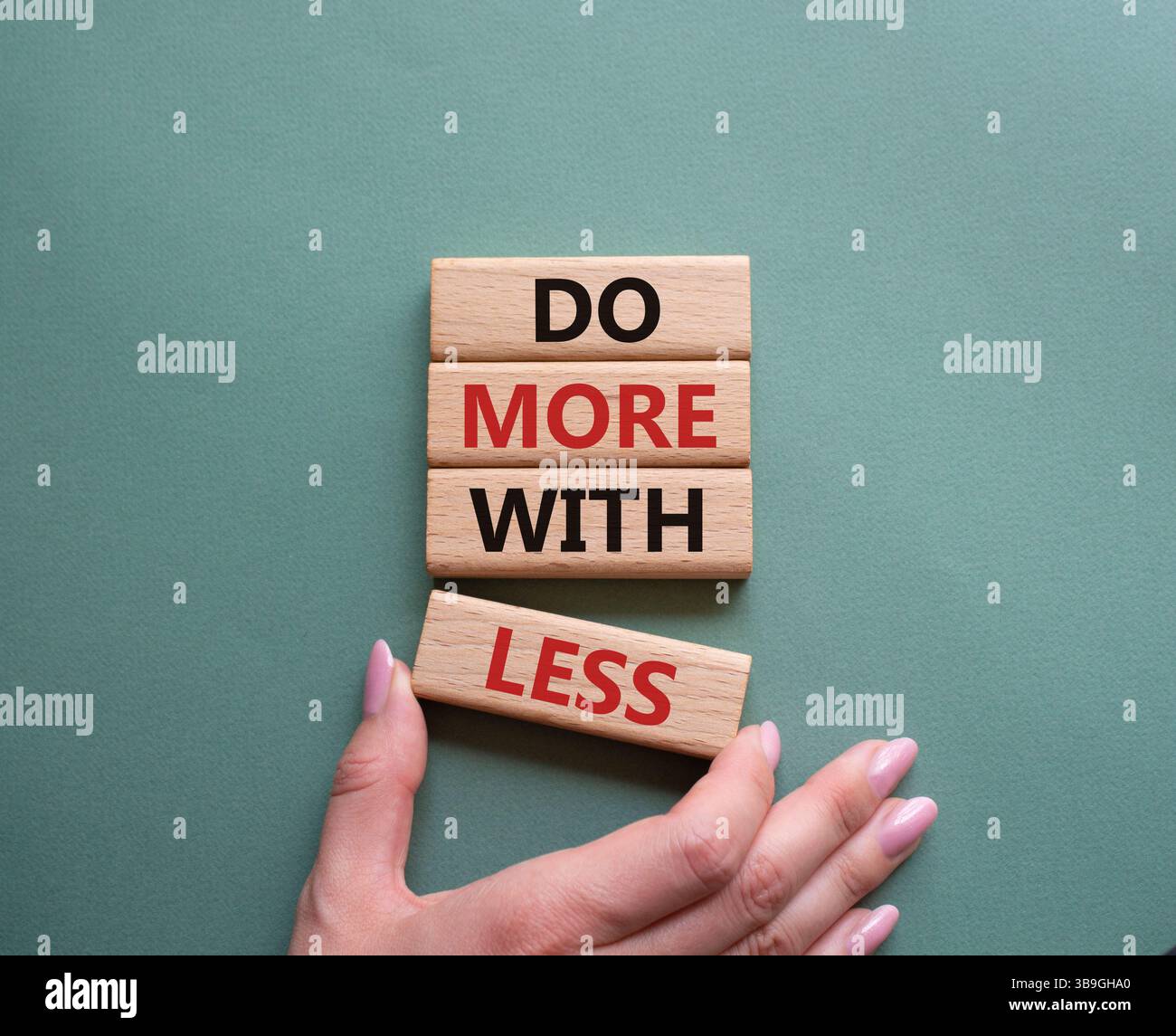 Do more with less symbol. Concept words Do more with less on wooden ...