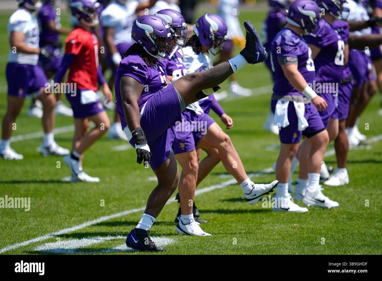 Minnesota Vikings guard Donovan Jackson (74), front, stretches during ...