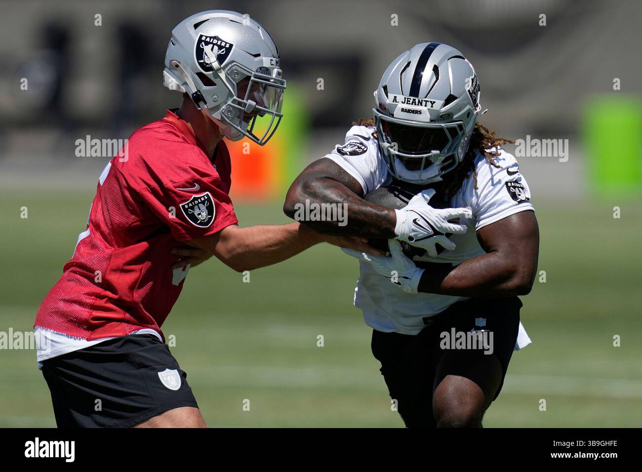 Las Vegas Raiders' quarterback Cam Miller hands off a ball to Ashton ...