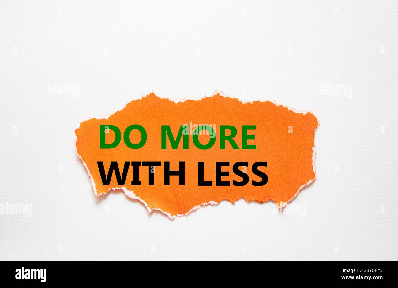 Do more with less symbol. Concept words Do more with less on torn orange paper. Beautiful white ...