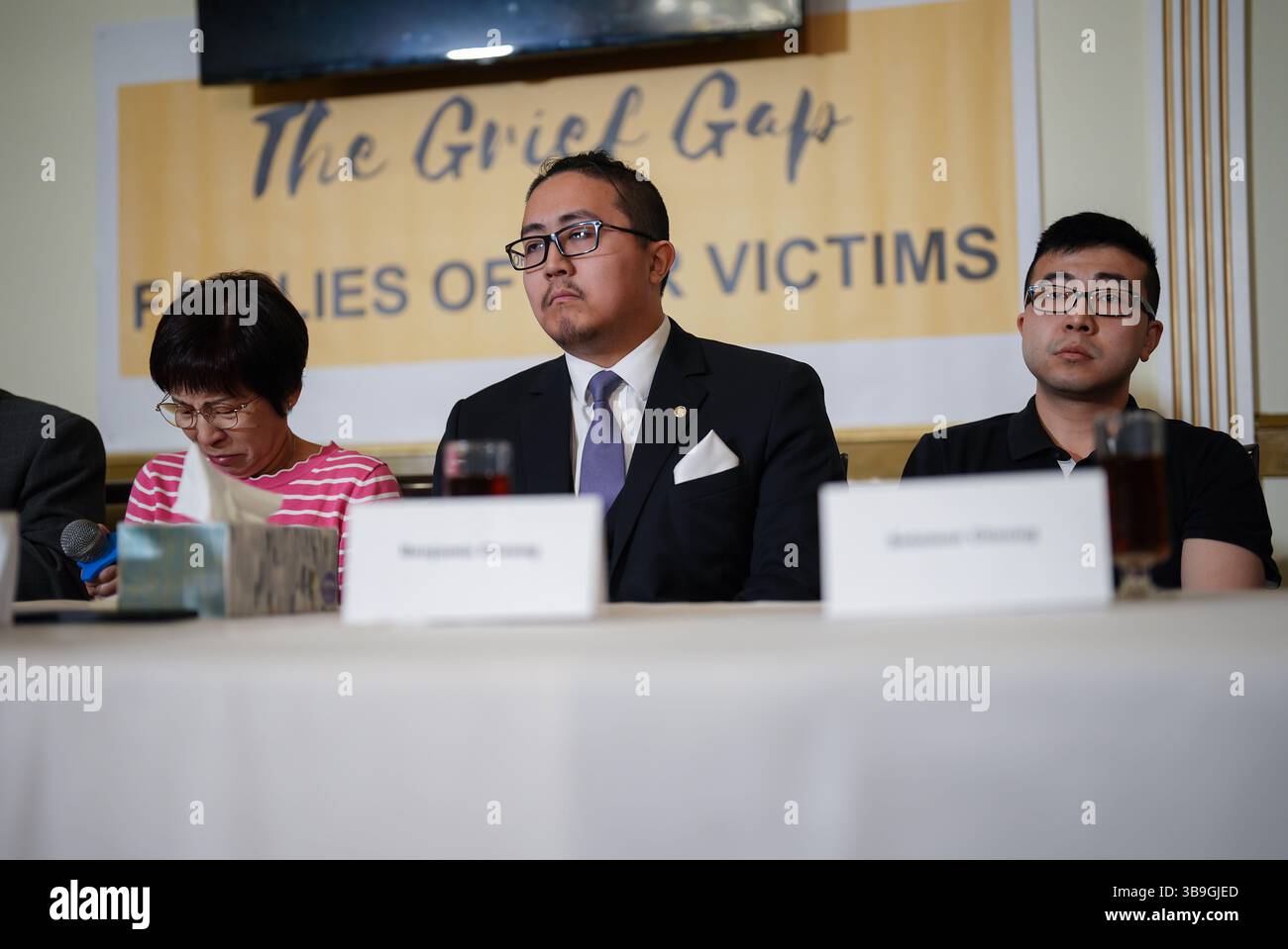 Athens Cheung, left, pauses after speaking about her late husband Rev ...