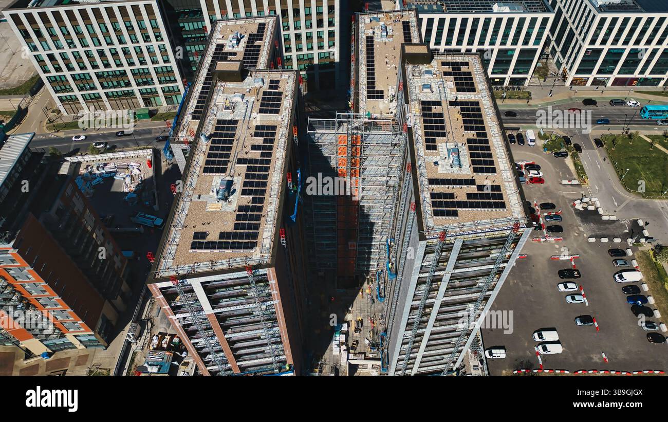 Aerial view of multiple buildings including buildings with solar panels ...