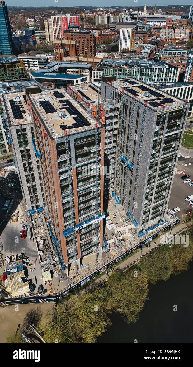Aerial view of three tall buildings under construction in an urban area ...