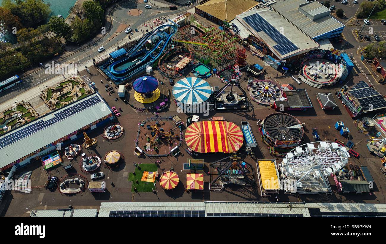 Aerial view of a colorful amusement park with various rides, buildings ...