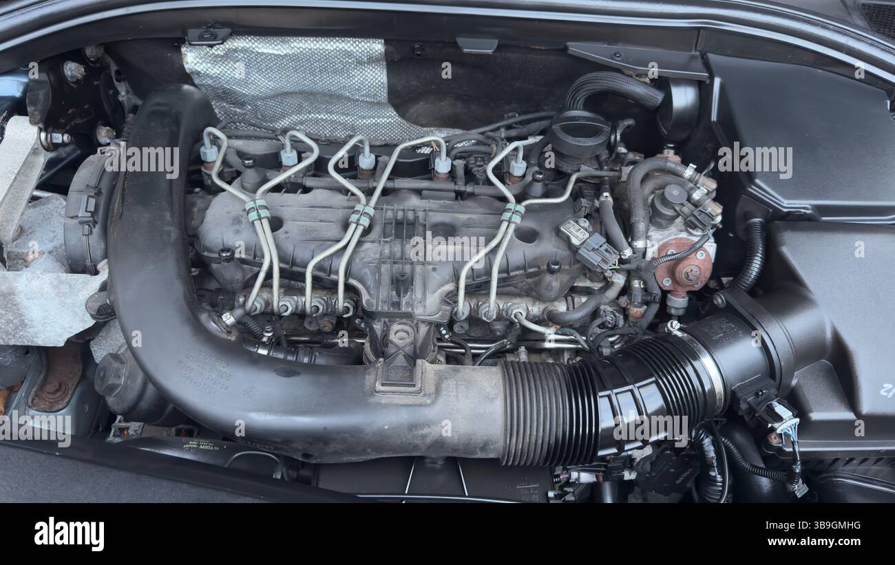 A detailed view of a car engine bay, focusing on the engine block ...