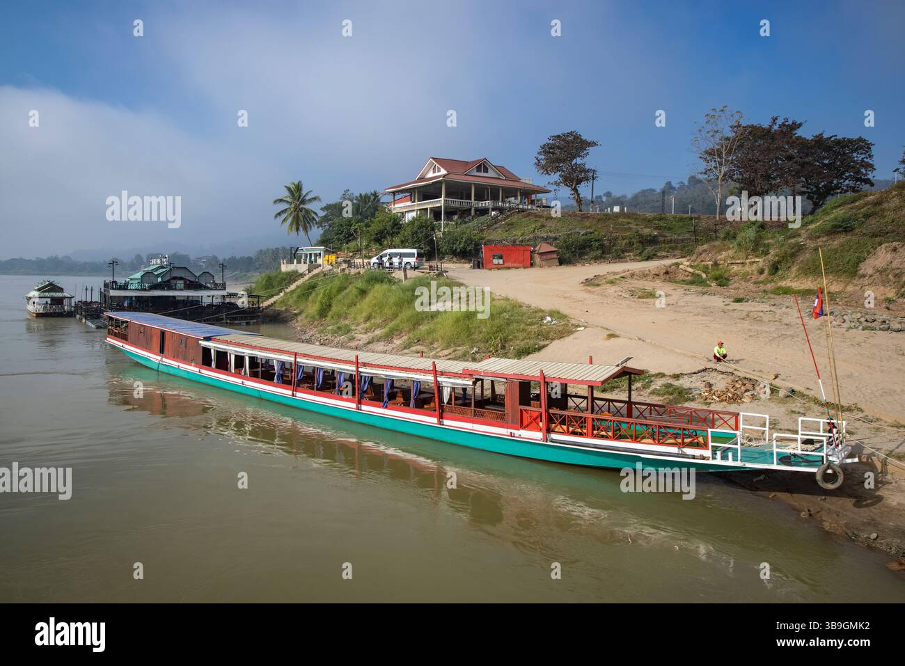 Slow boat (longtail boat) along the banks of the Upper Mekong, Pak Lay ...