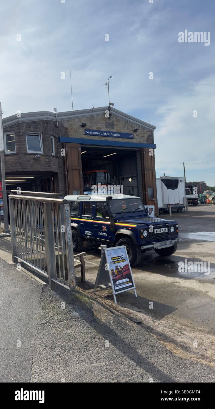 Image shows a blue Land Rover in front of the Seahouses Lifeboat ...