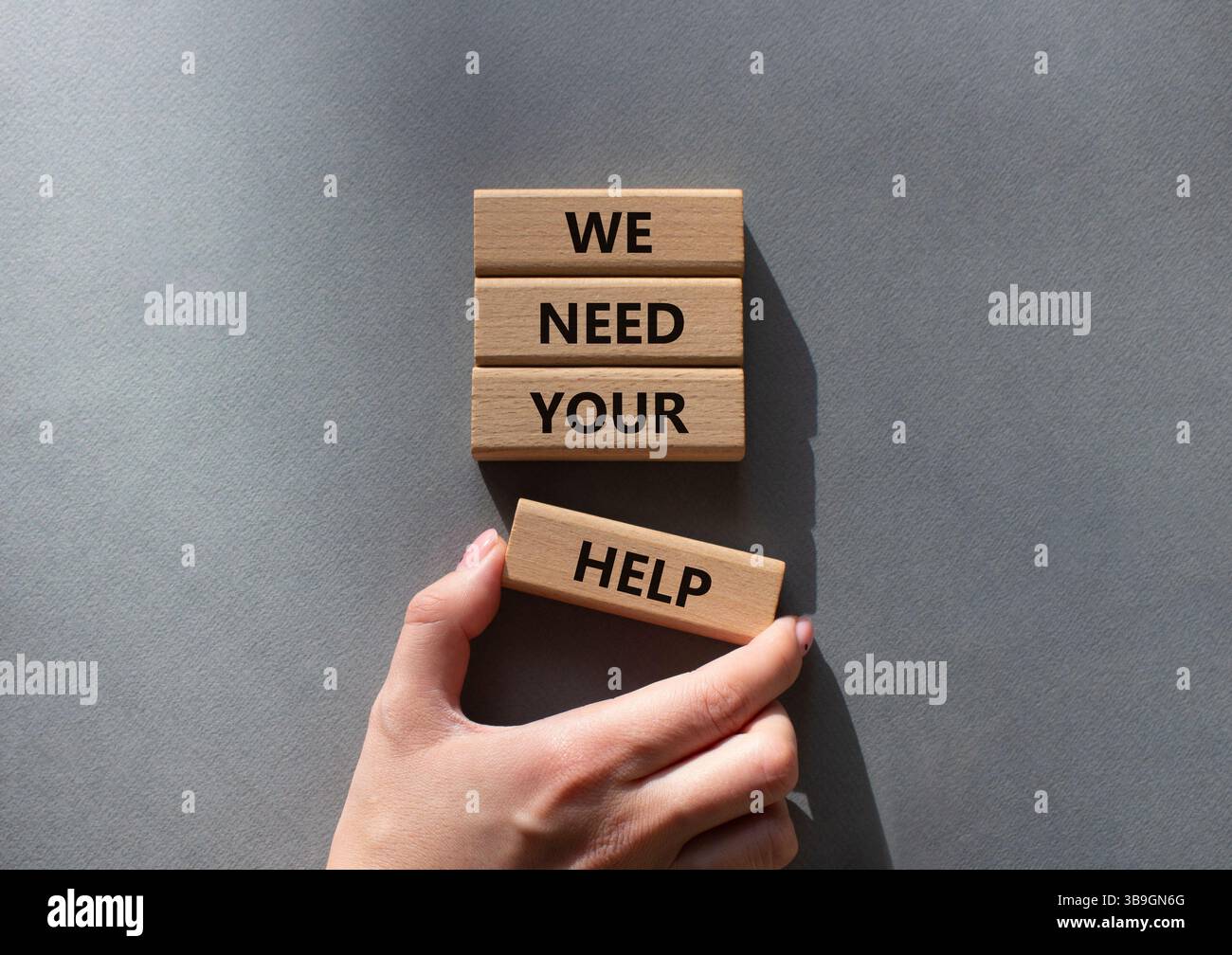 We need your help symbol. Wooden blocks with words We need your help ...