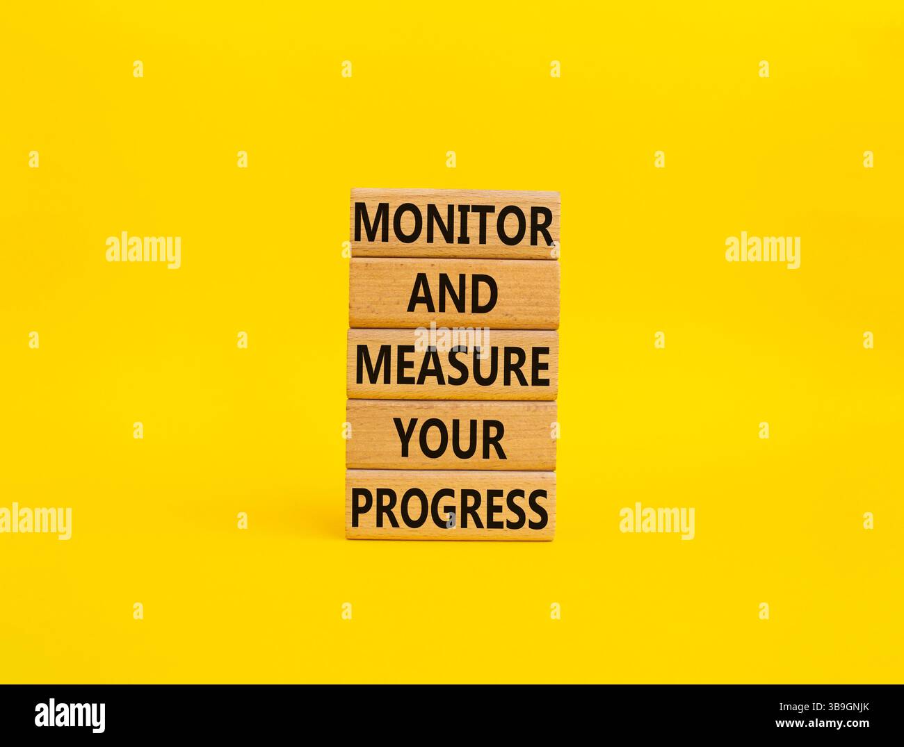 Monitor and Measure your Progress symbol. Wooden blocks with words ...