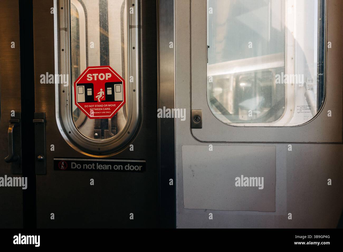 Stop sign on subway door in urban transit system during daylight hours ...