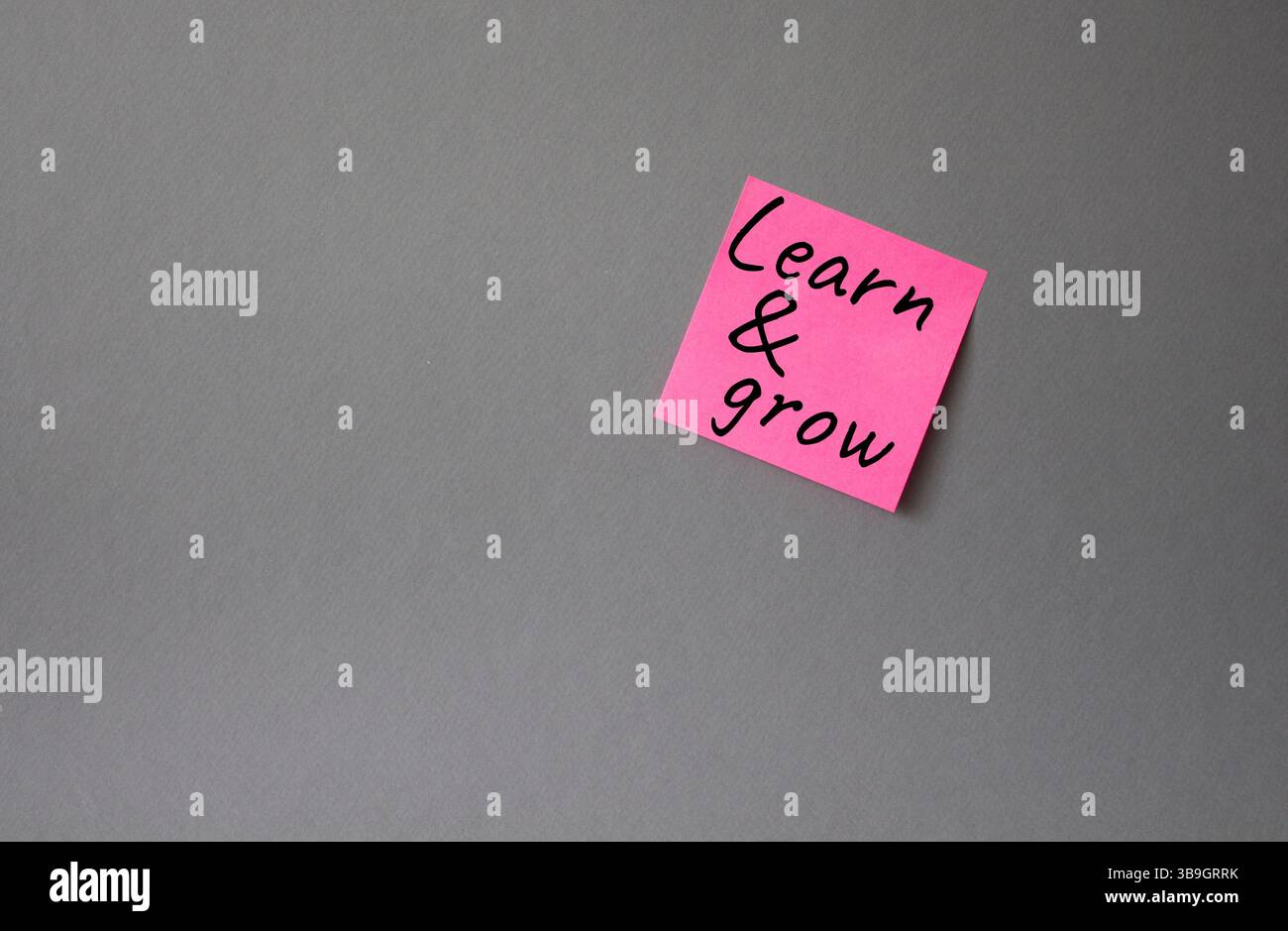 Learn and grow symbol. Concept words Learn and grow on pink steaky note ...