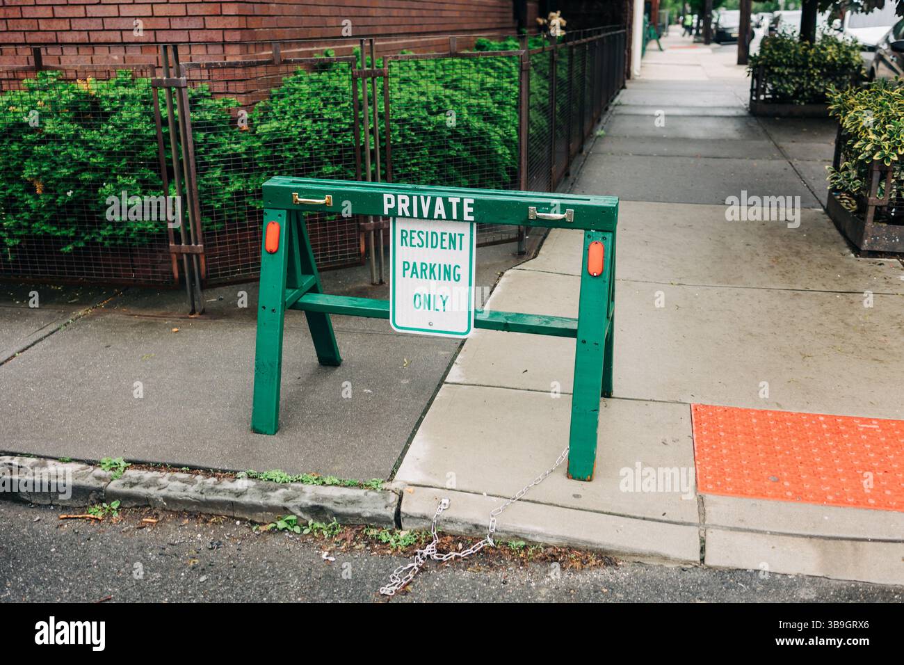 Private signage indicates resident parking only in a city neighborhood ...