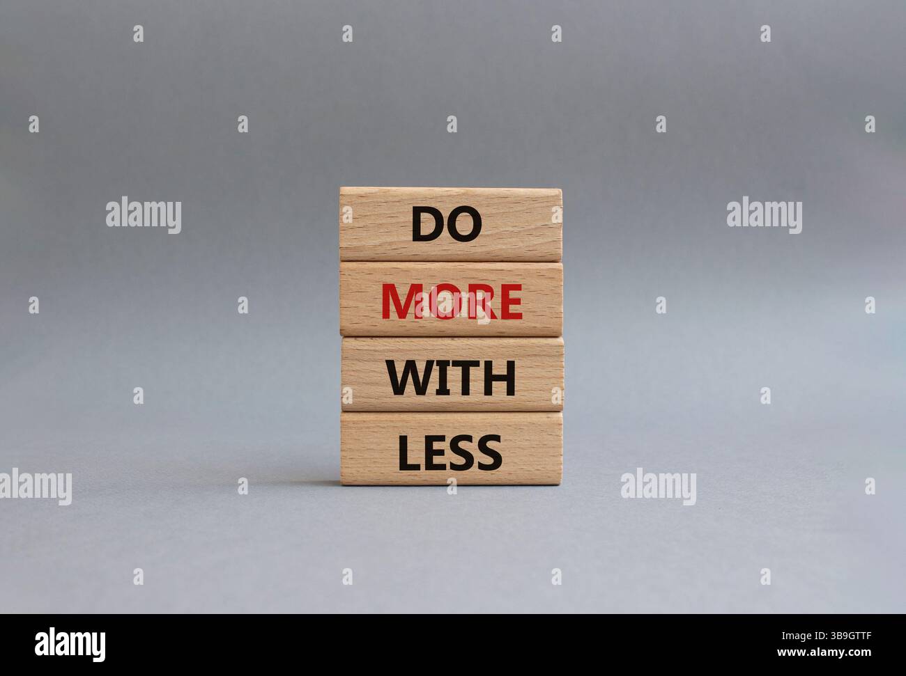 Do more with less symbol. Concept words Do more with less on wooden ...