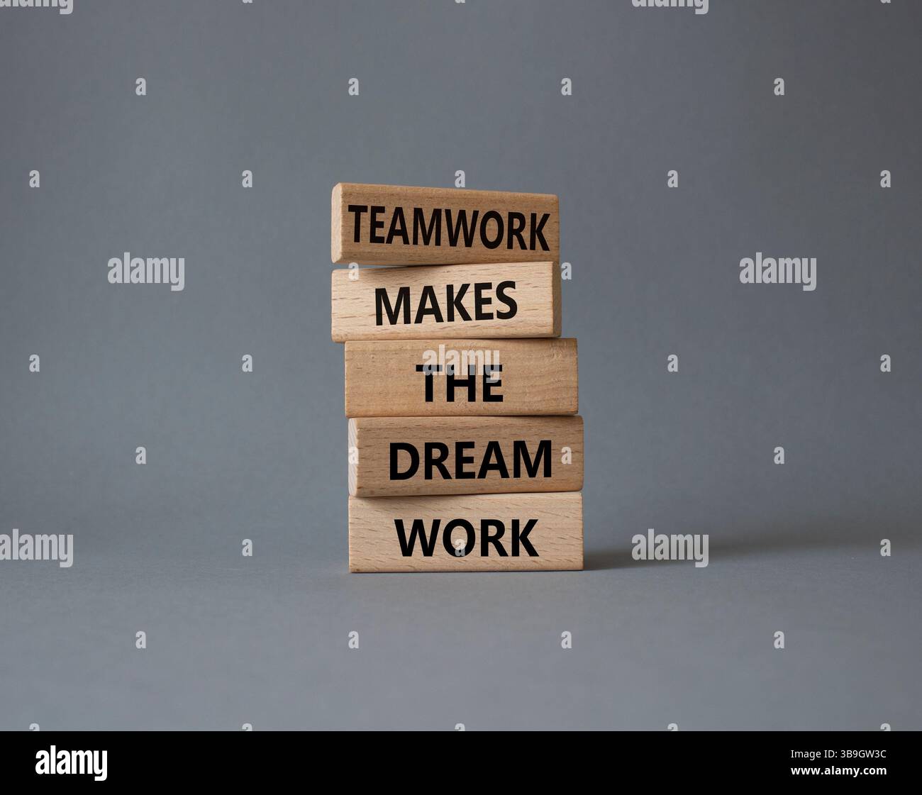 Teamwork symbol. Wooden blocks with words Teamwork makes the Dream work ...