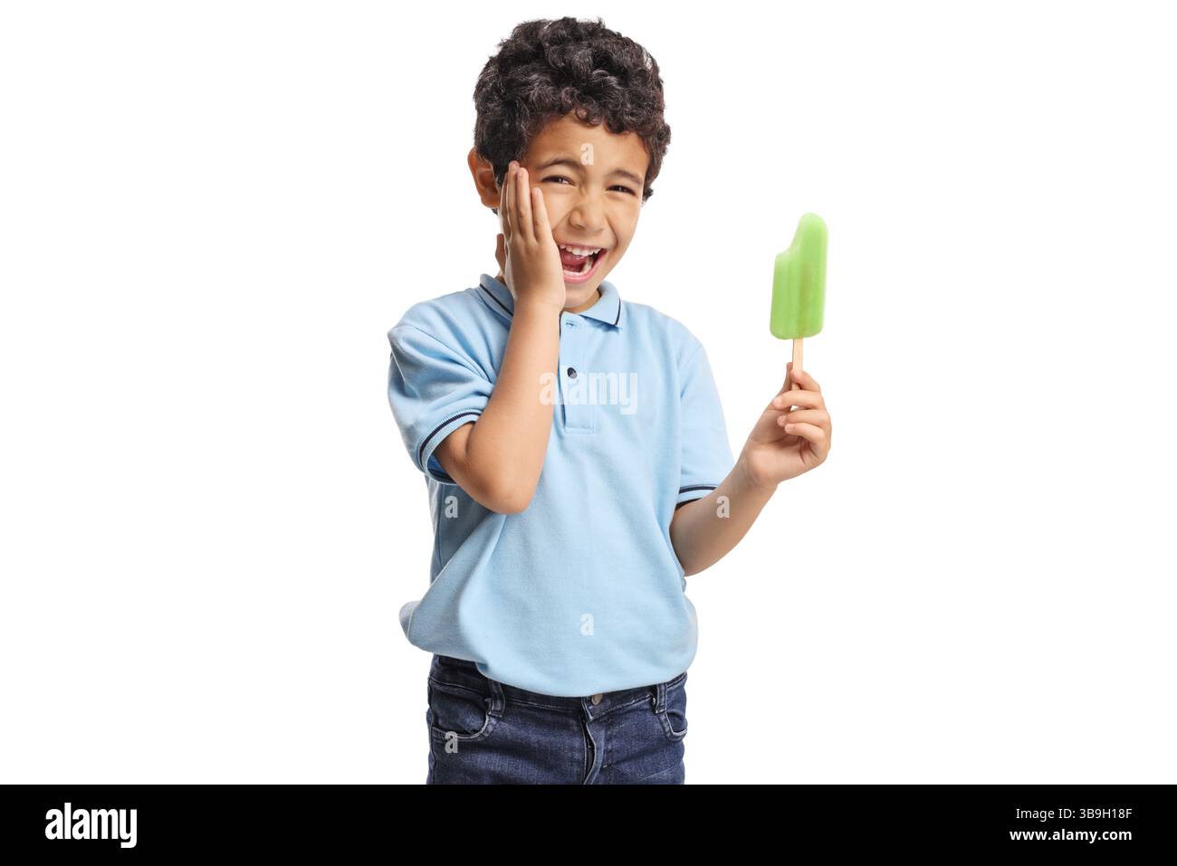 Boy with a lollipop ice cream holding his cheek and having a toothache ...
