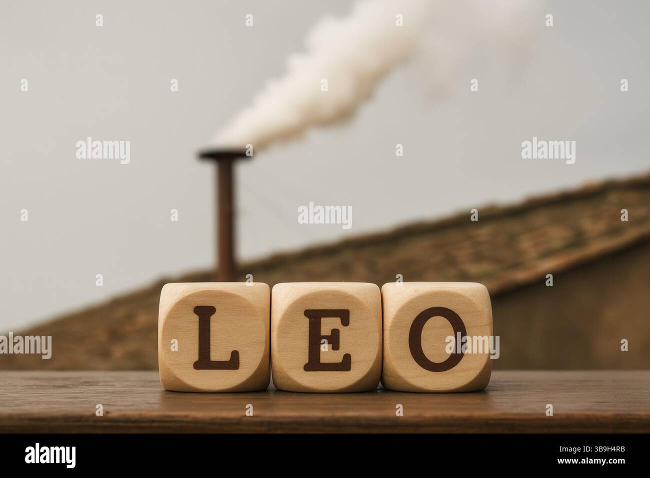 Wooden dice form the name Leo the next pope, against a backdrop of a smoking chimney, hinting at ...