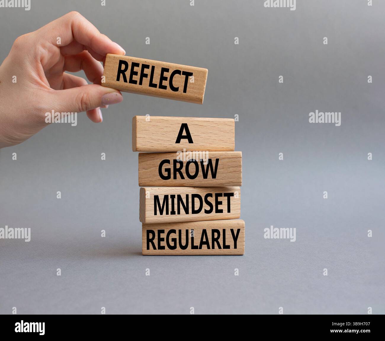 Refclect a grow mindset regularly symbol. Wooden blocks with words ...