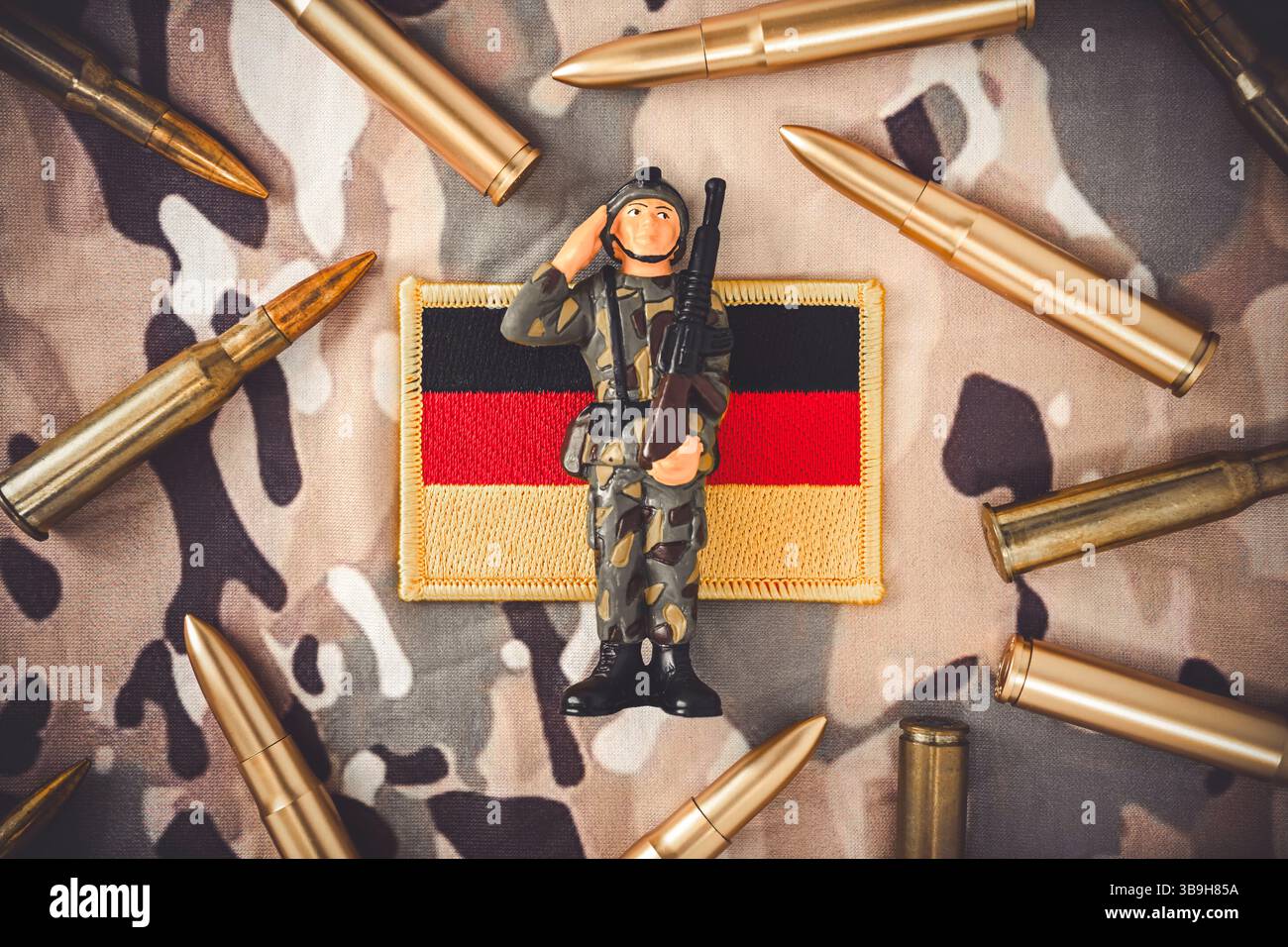 Figure of a soldier on a German flag surrounded by cartridges, symbolic ...