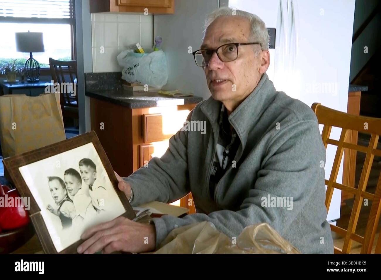 John Prevost, brother of new Pope Leo XIV, holds a portrait of the ...