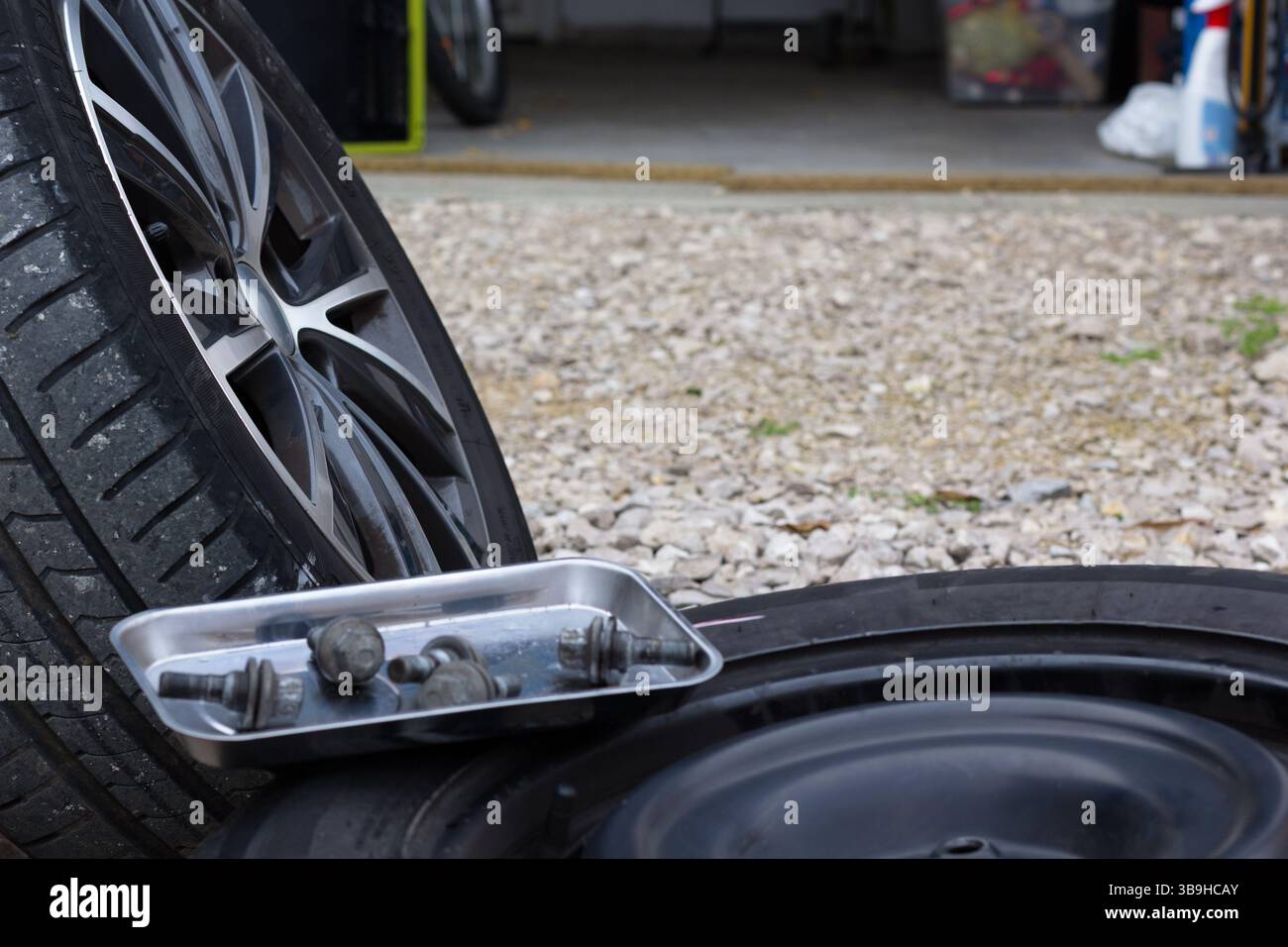 Manually changing tires for the summer season Stock Photo - Alamy