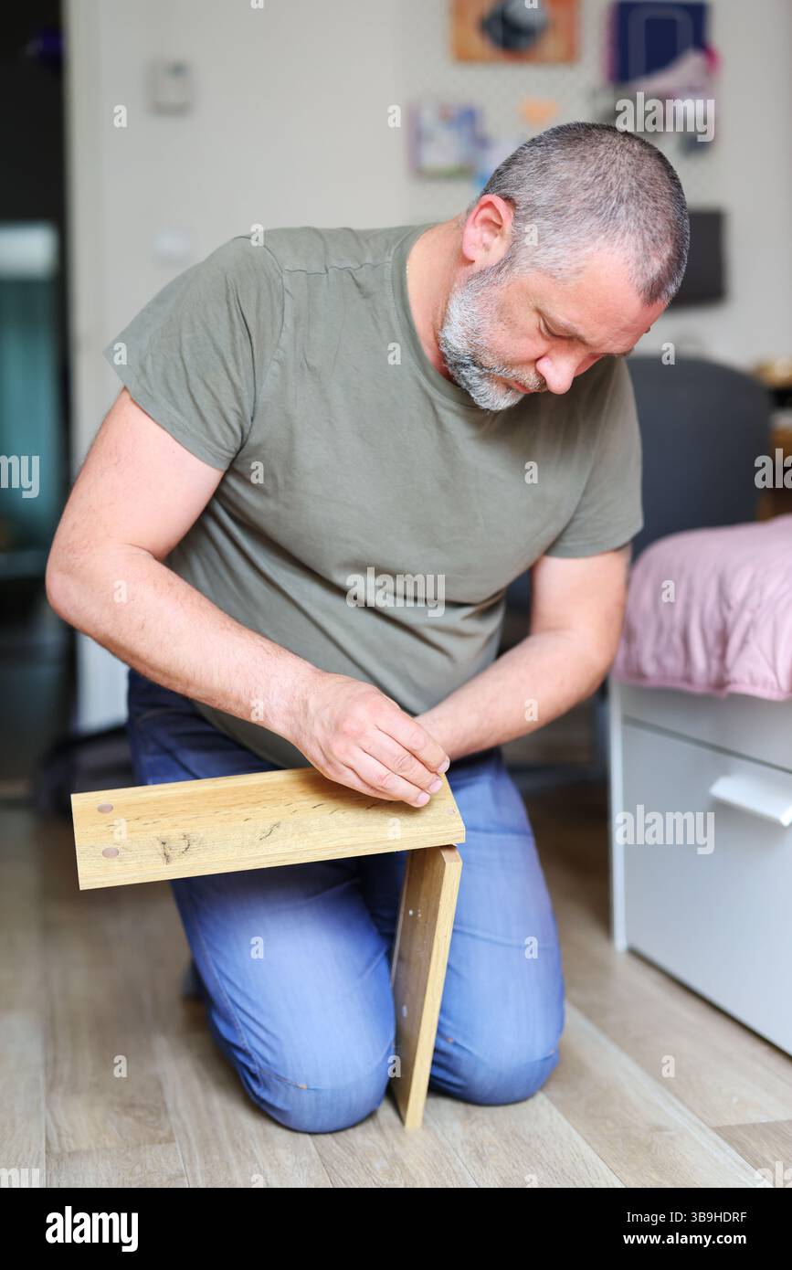 Man using screwdriver screw furniture hi-res stock photography and ...
