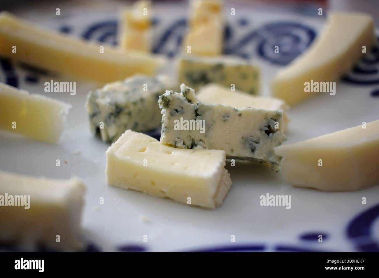 some types of cheese on a plate ready to eat Stock Photo - Alamy