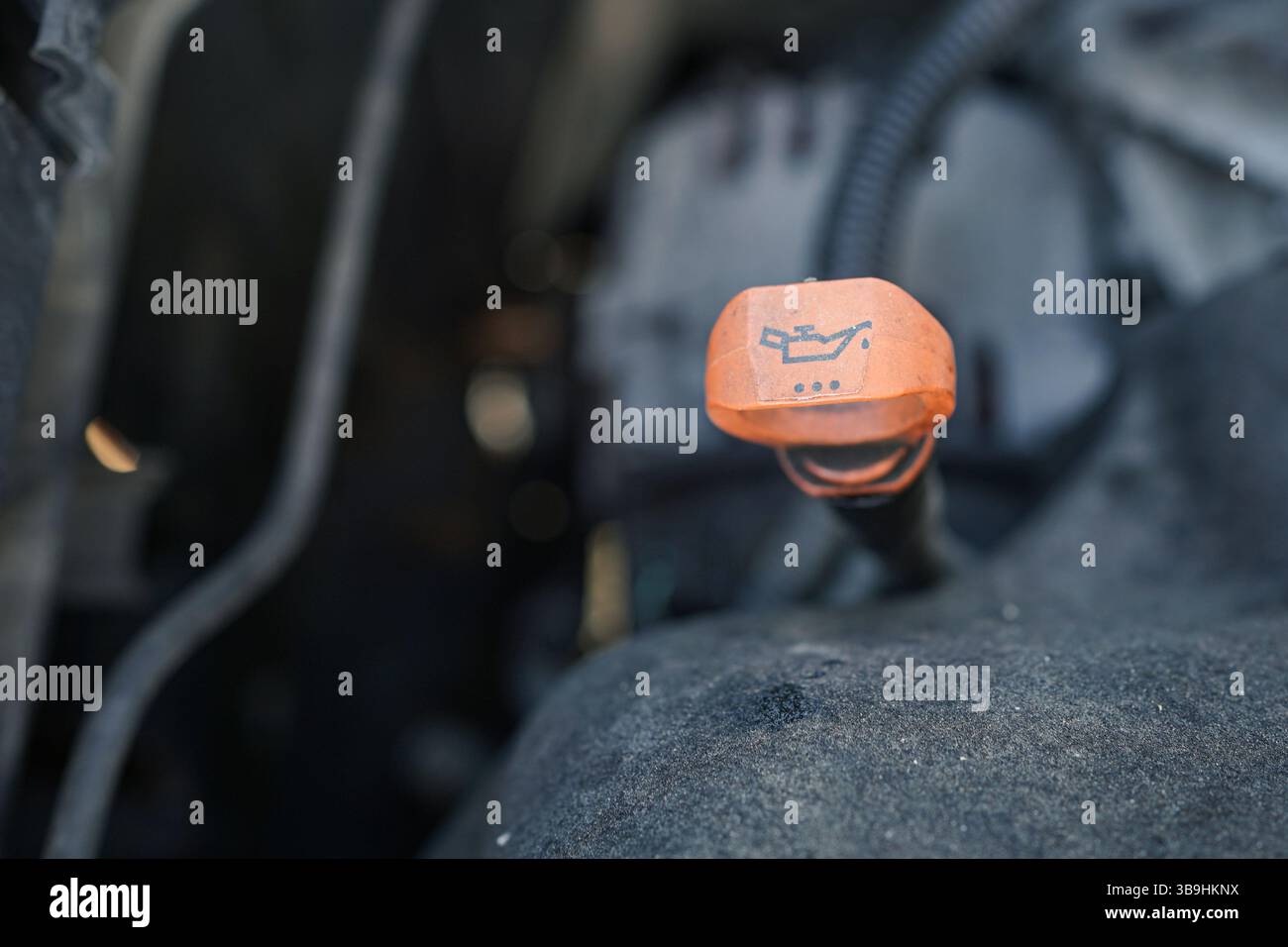 A car engine oil dipstick is being used to check the oil level Stock Photo - Alamy