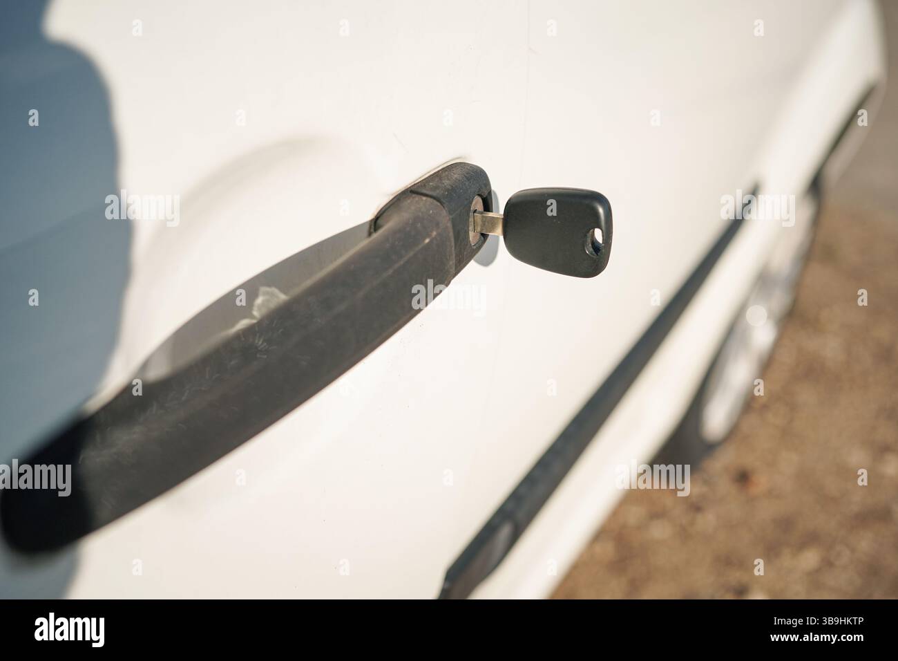 A car key is stuck in the door handle Stock Photo - Alamy