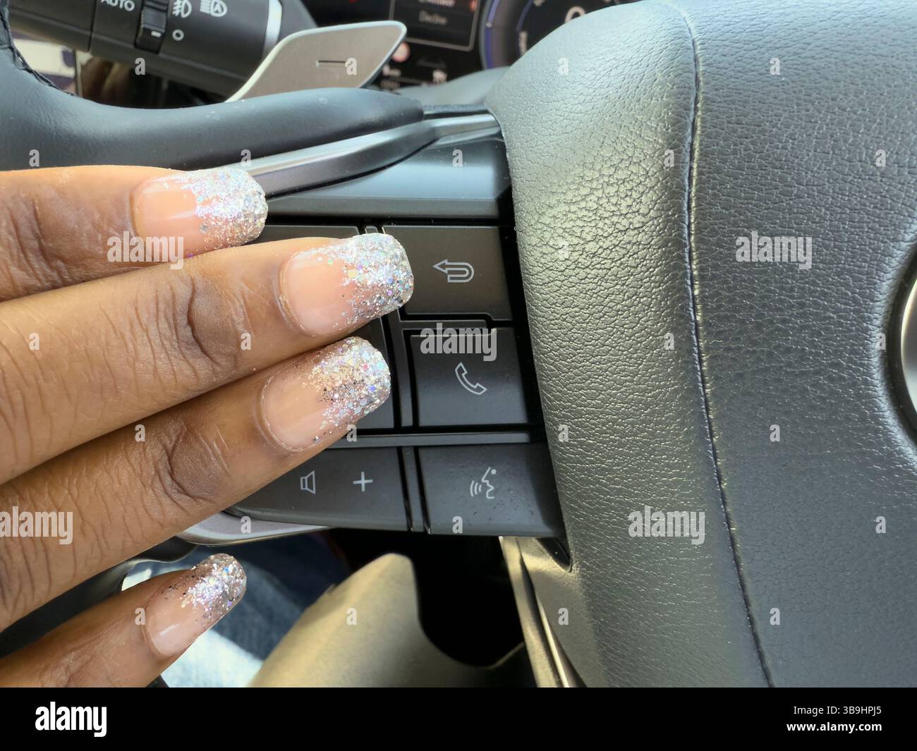 England UK, 27.04.2025. Womans decorated finger nails using hand ...