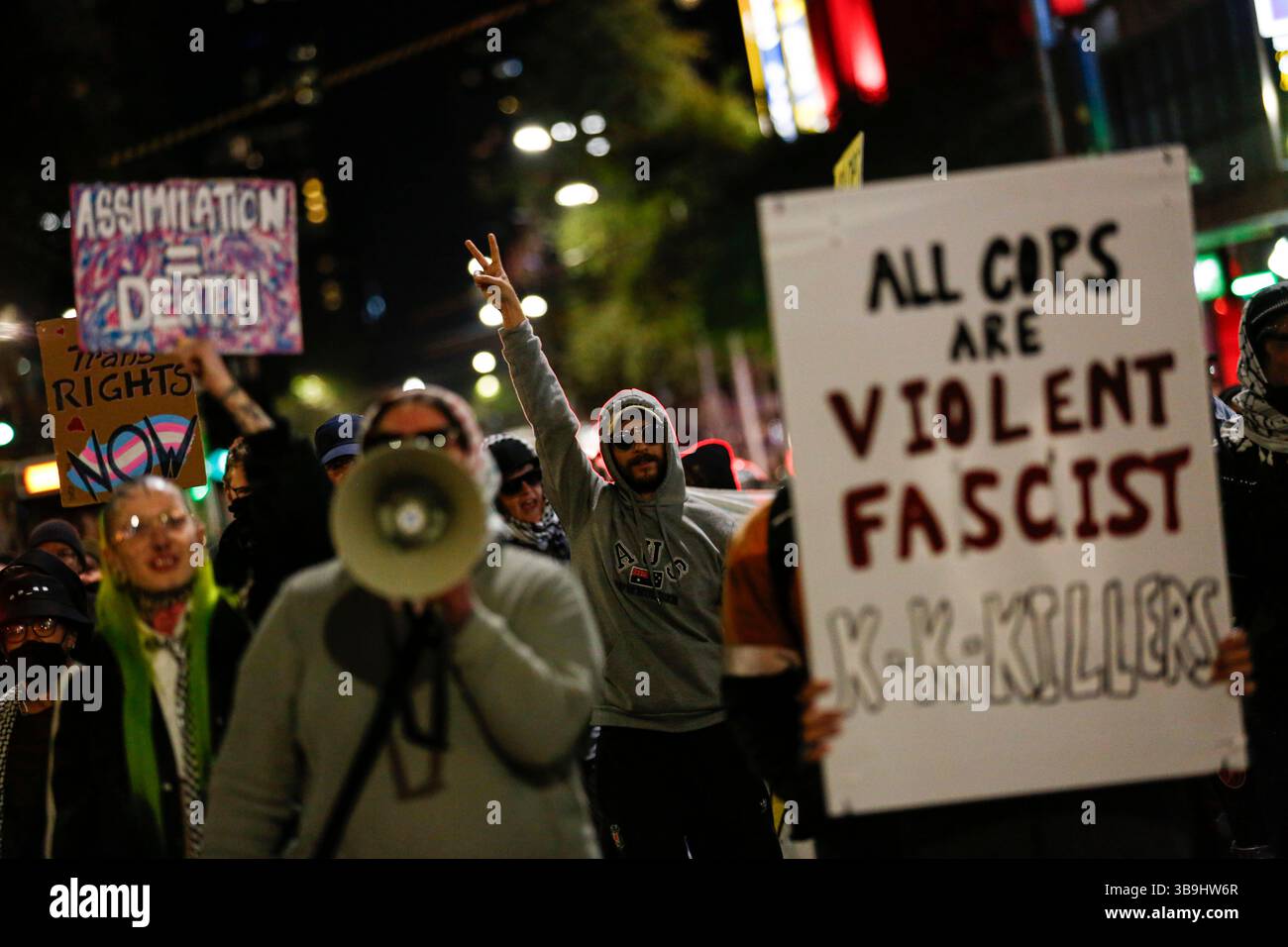 A protester raises hand with peace sign during the rally. A snap rally ...