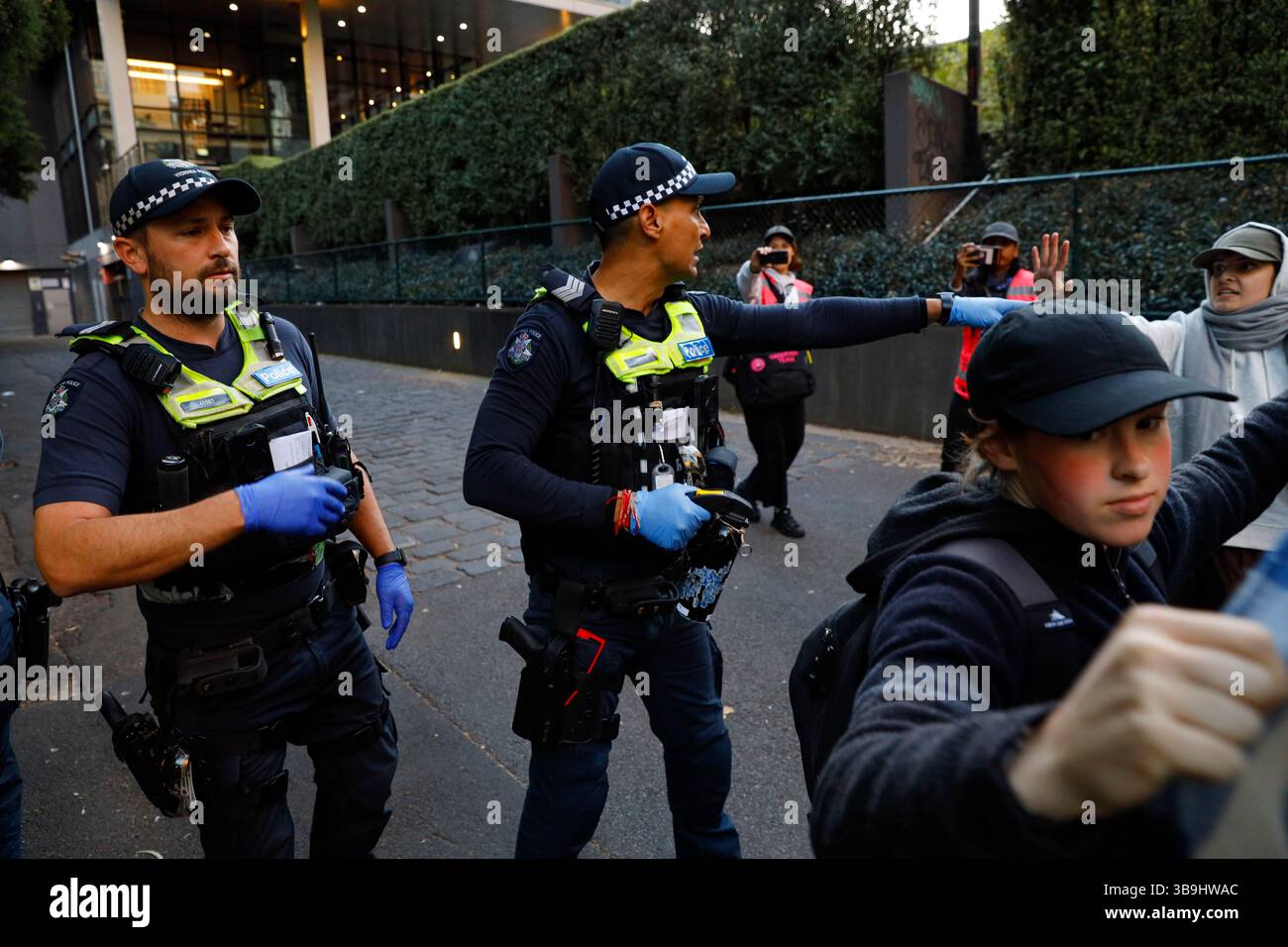 A Victoria Police officer shouts at a protester during the rally. A ...