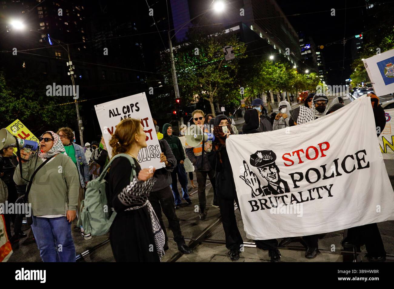 Protesters hold banners as they march during the rally. A snap rally ...