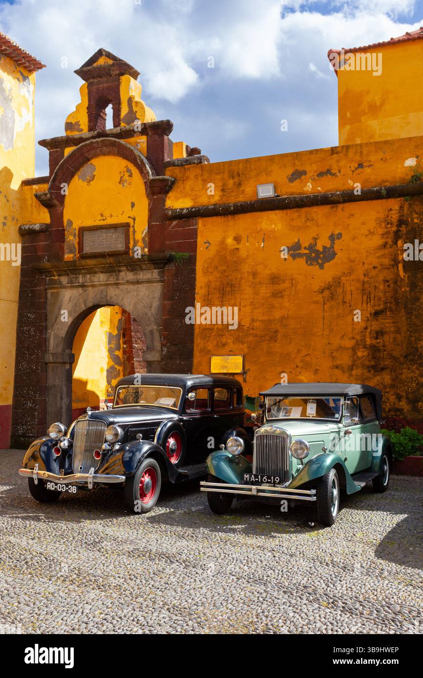 Vintage cars by the entrance of the Fortress of São Tiago, the iconic ...