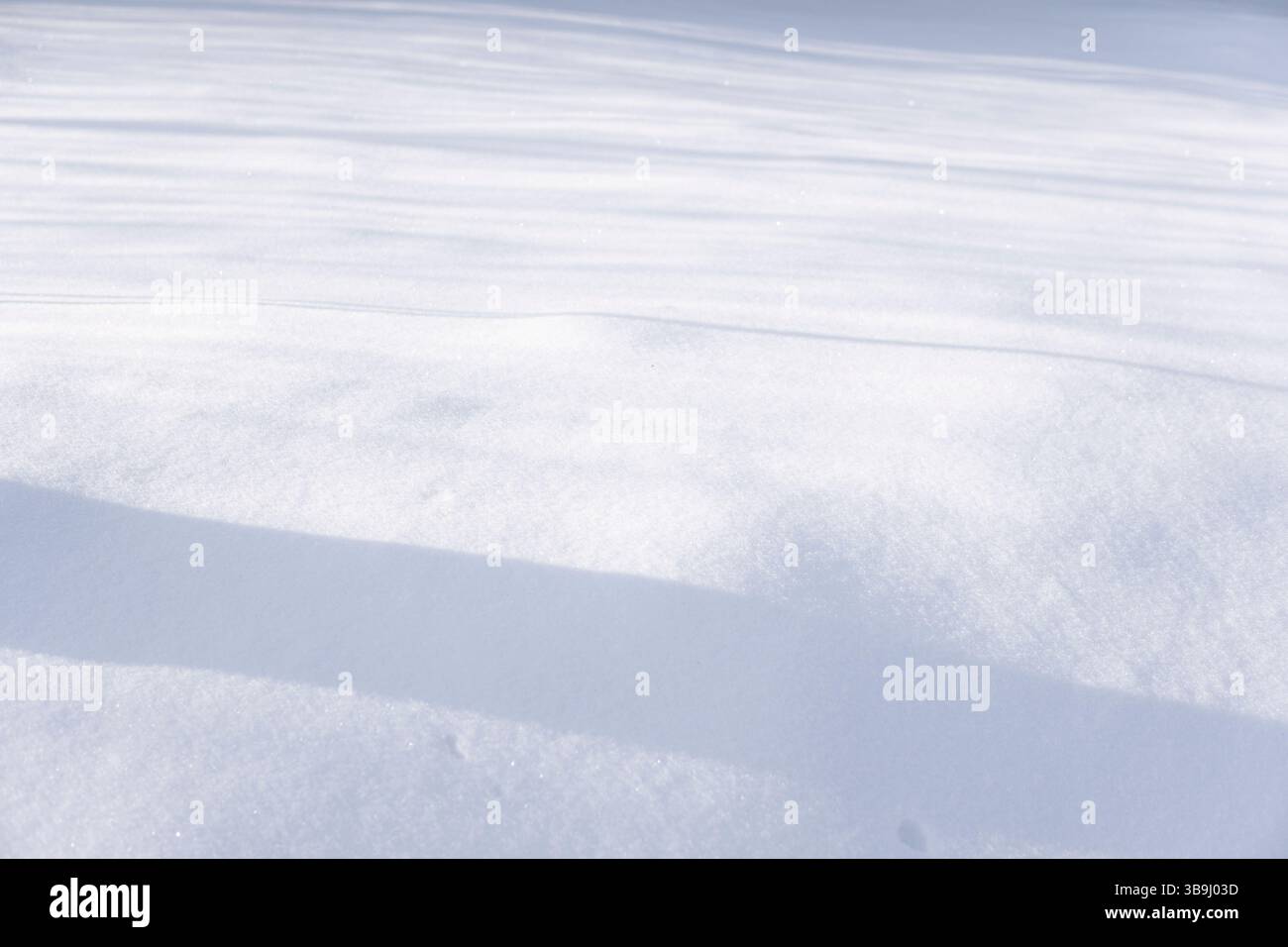 Wide soft snow cover with horizontal shadows stretching across the ...