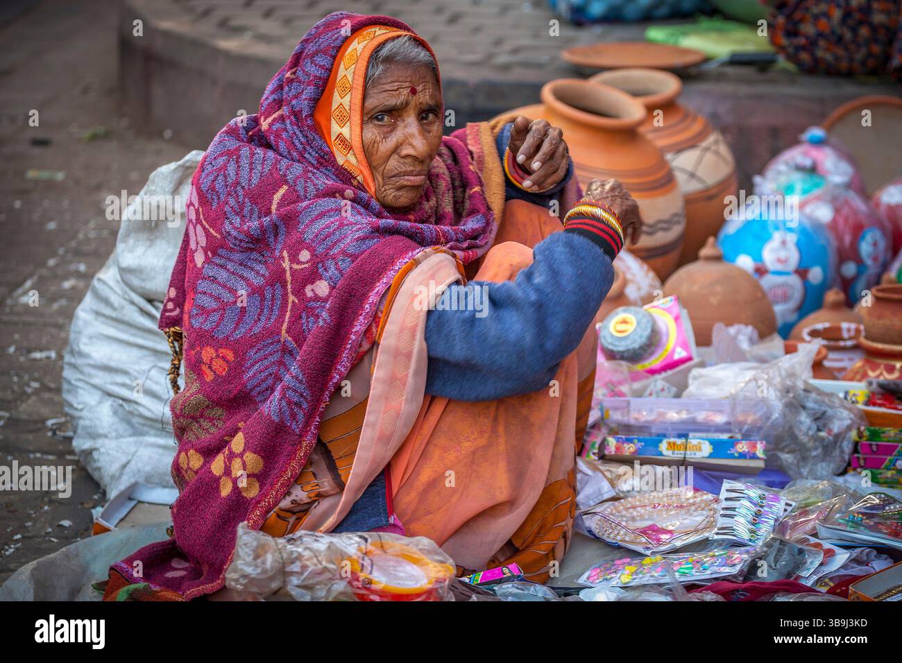 Local Indian woman selling goods in a street market, Jaipur, India ...